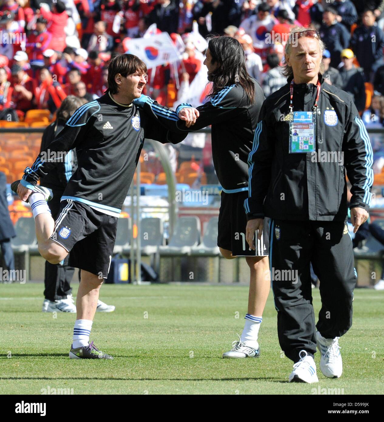 Argentina's Lionel Messi (L) and Jonas Gutierrez stretch during warm up ...