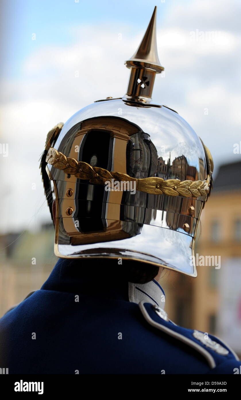 Parts of the royal palace reflect in the helmet of a Royal Guard ...