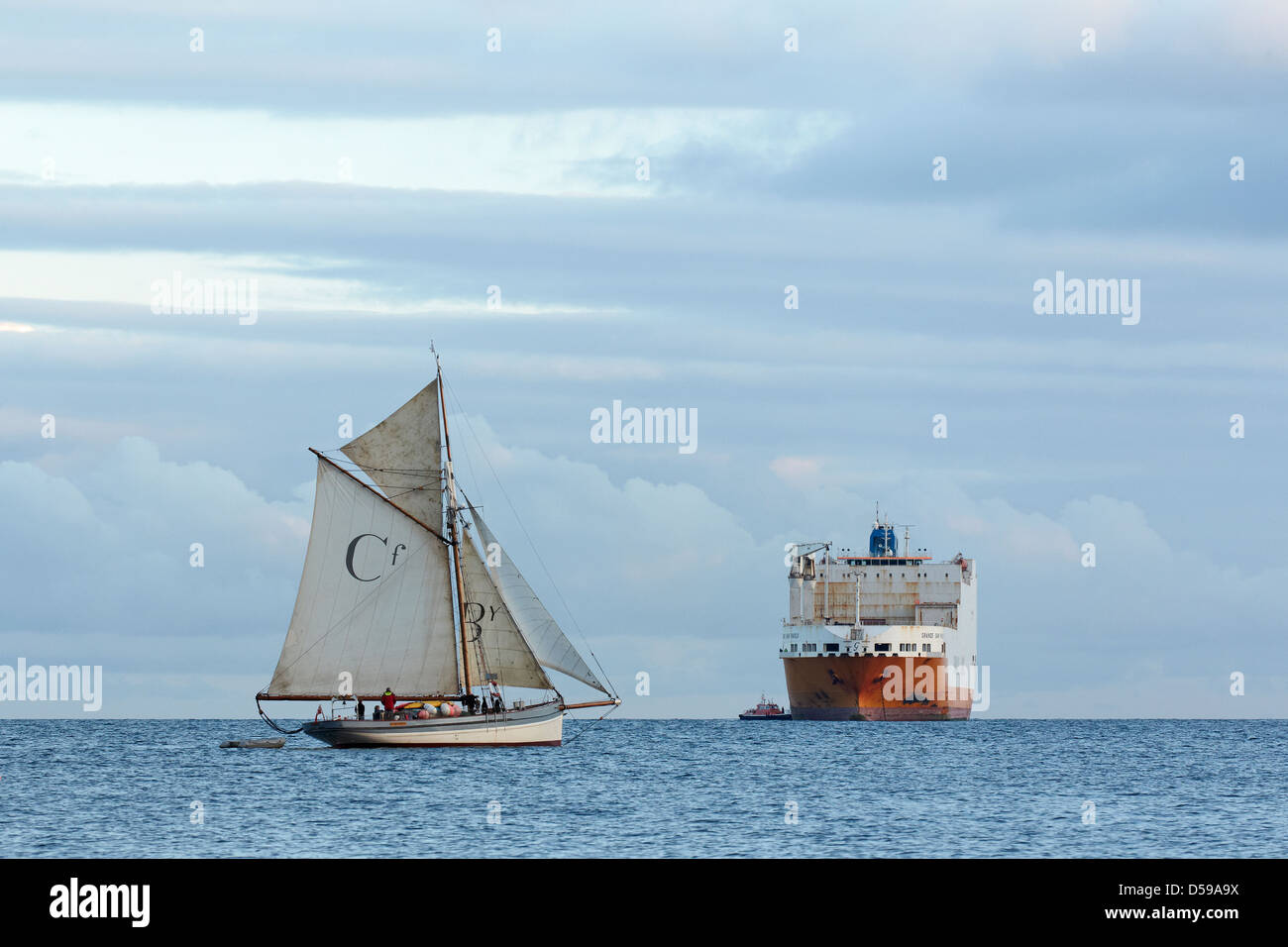 Yacht next to ship out at sea Stock Photo - Alamy