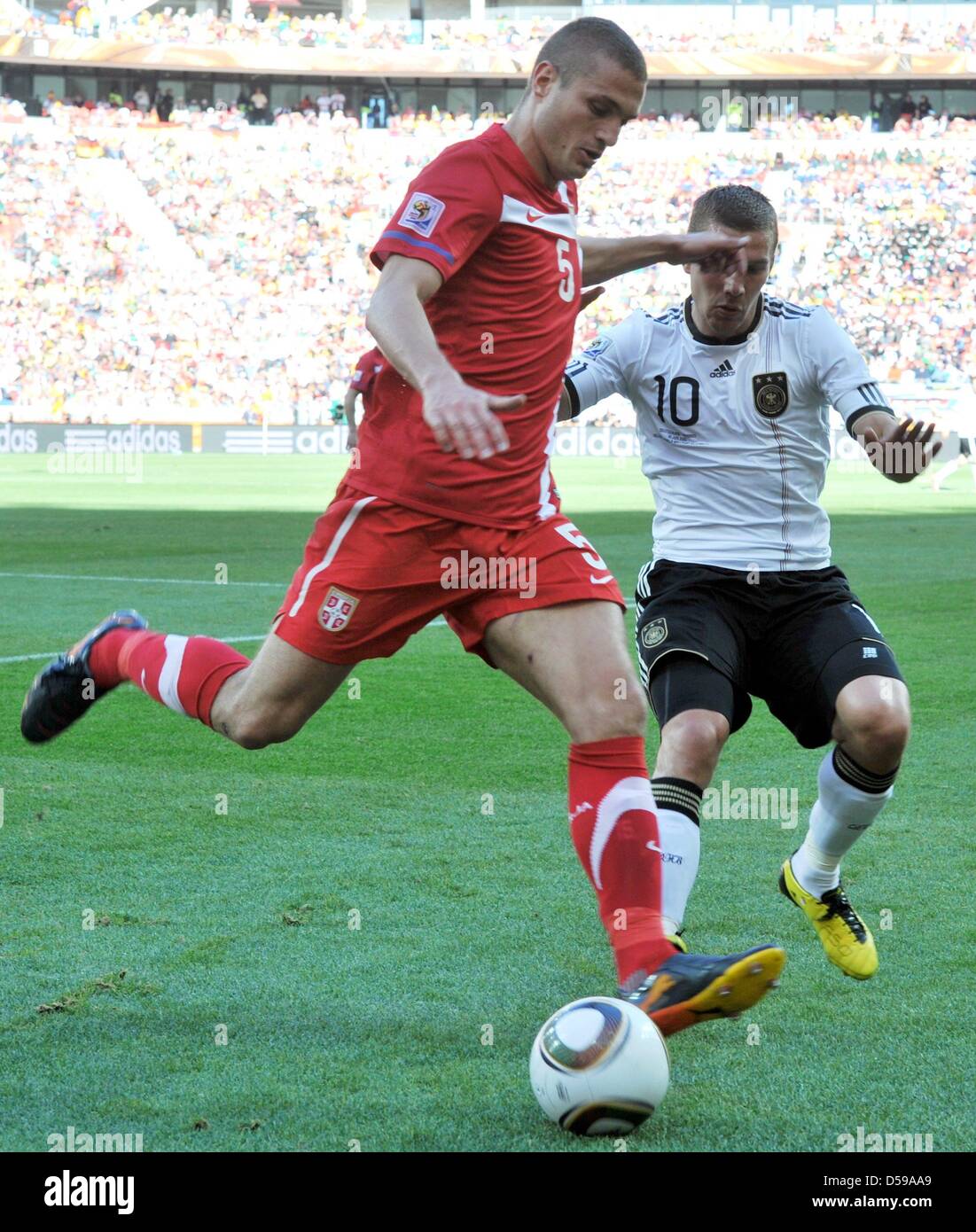 Lukas Podolski (R) of Germany vies with Nemanja Vidic of Serbia during ...