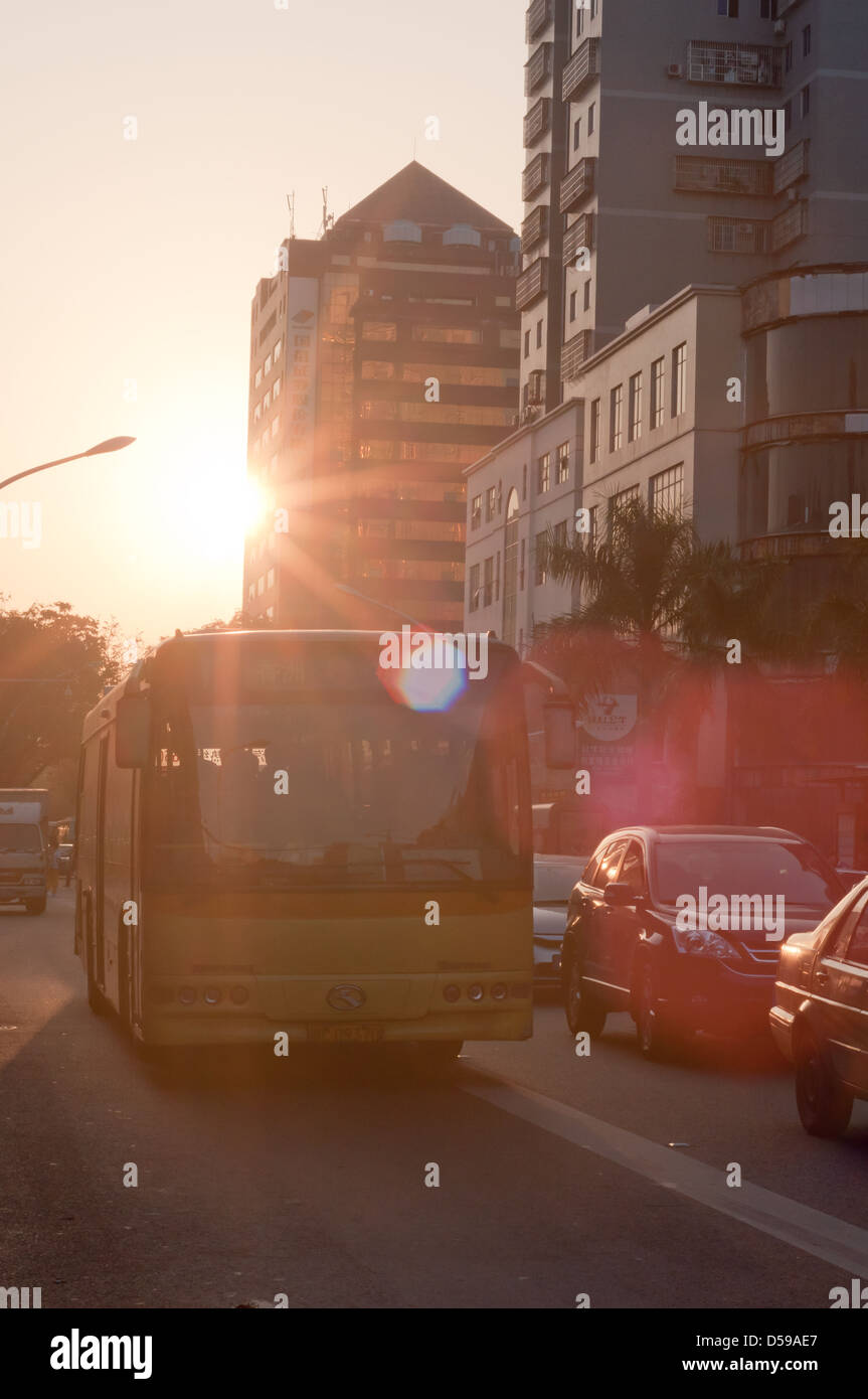 The city's bus in the streets of Sunset Stock Photo - Alamy