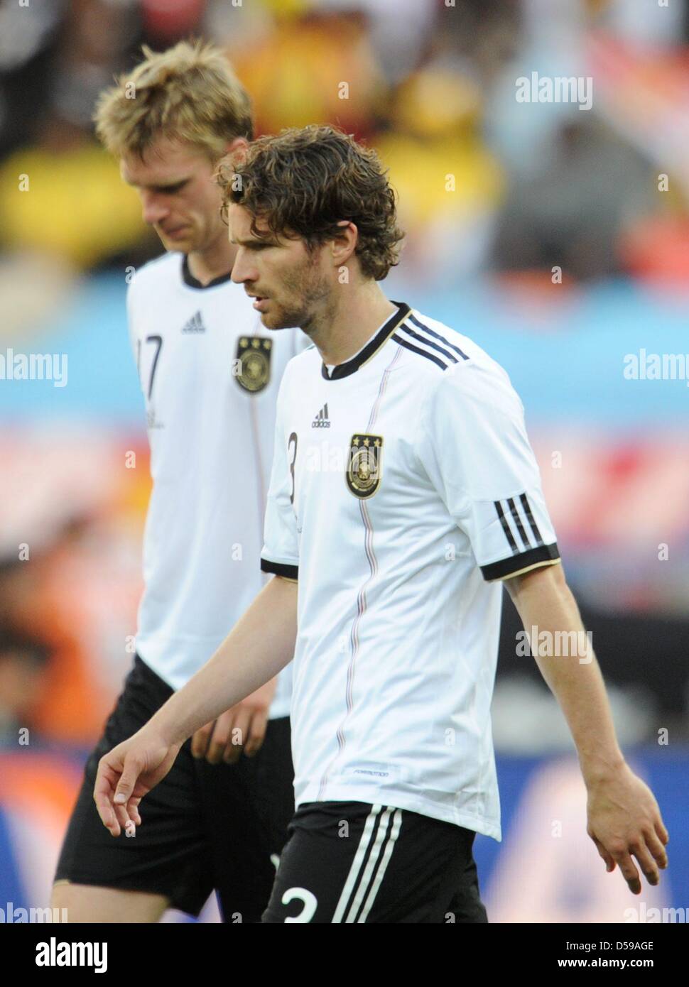 Per Mertesacker (L) and Arne Friedrich of Germany leave the pitch after ...
