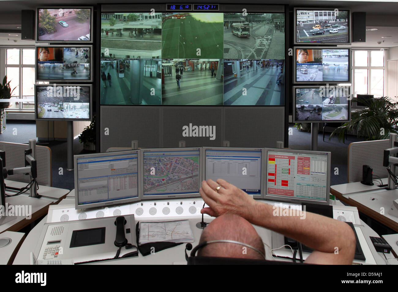 Police officers watch CCTV monitors and one transmitting the Germany ...
