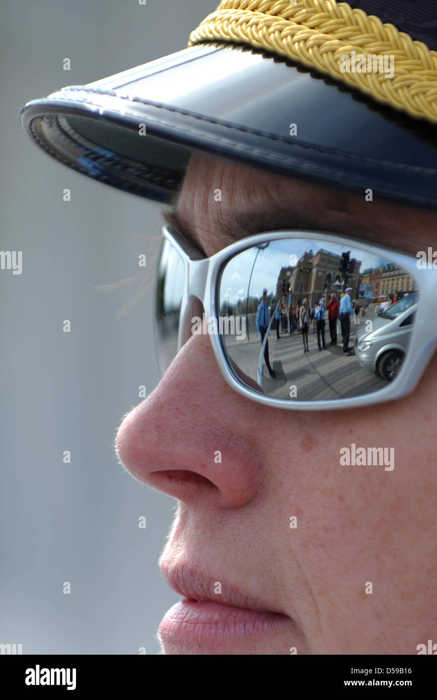 A police officer is standing infront of the Royal Palace prior to the ...
