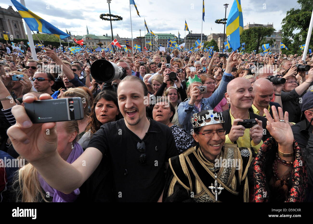 The crowd cheers when Crown Princess Victoria of Sweden and her husband ...
