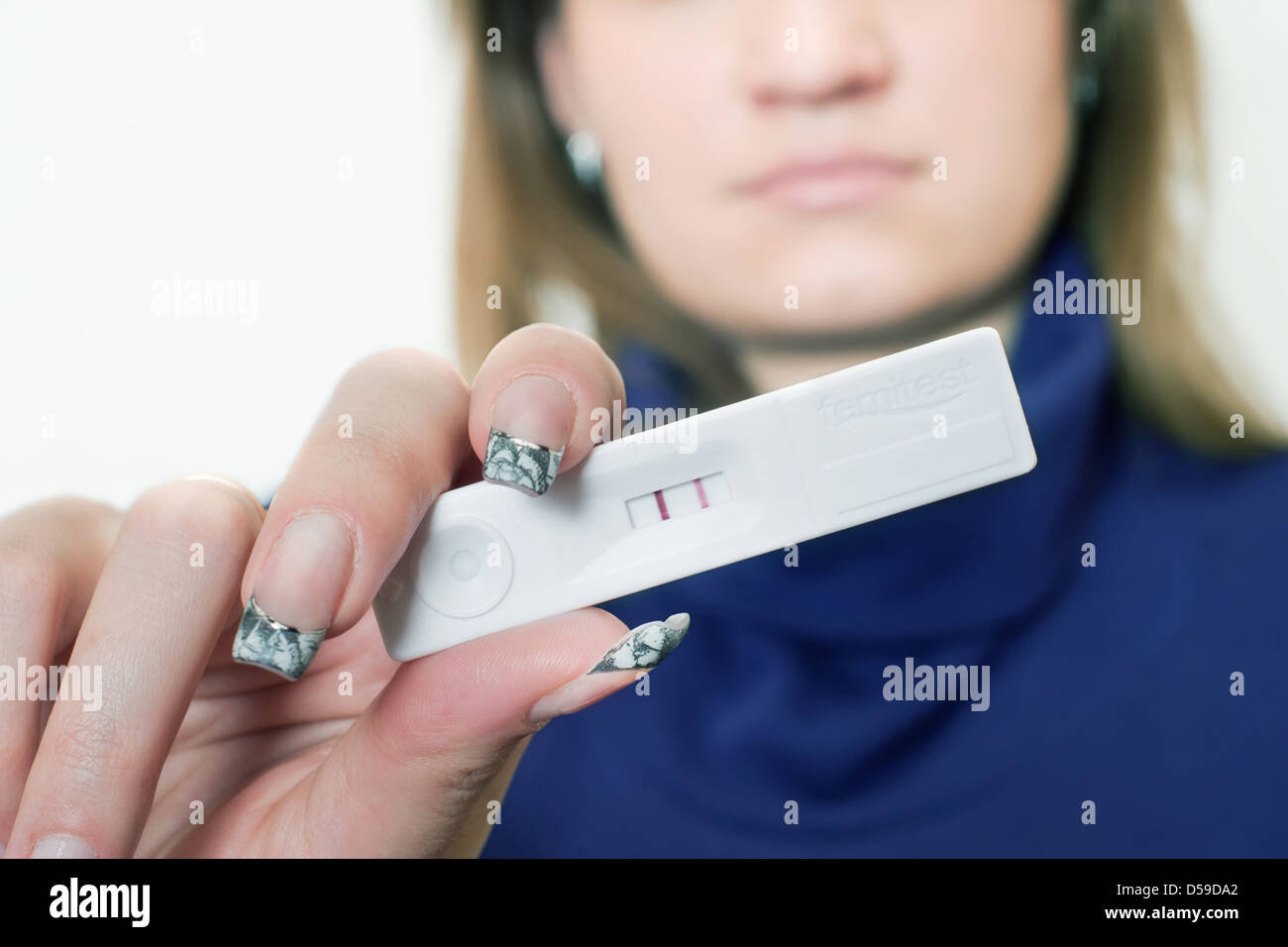 The girl shows the test for pregnancy Stock Photo - Alamy
