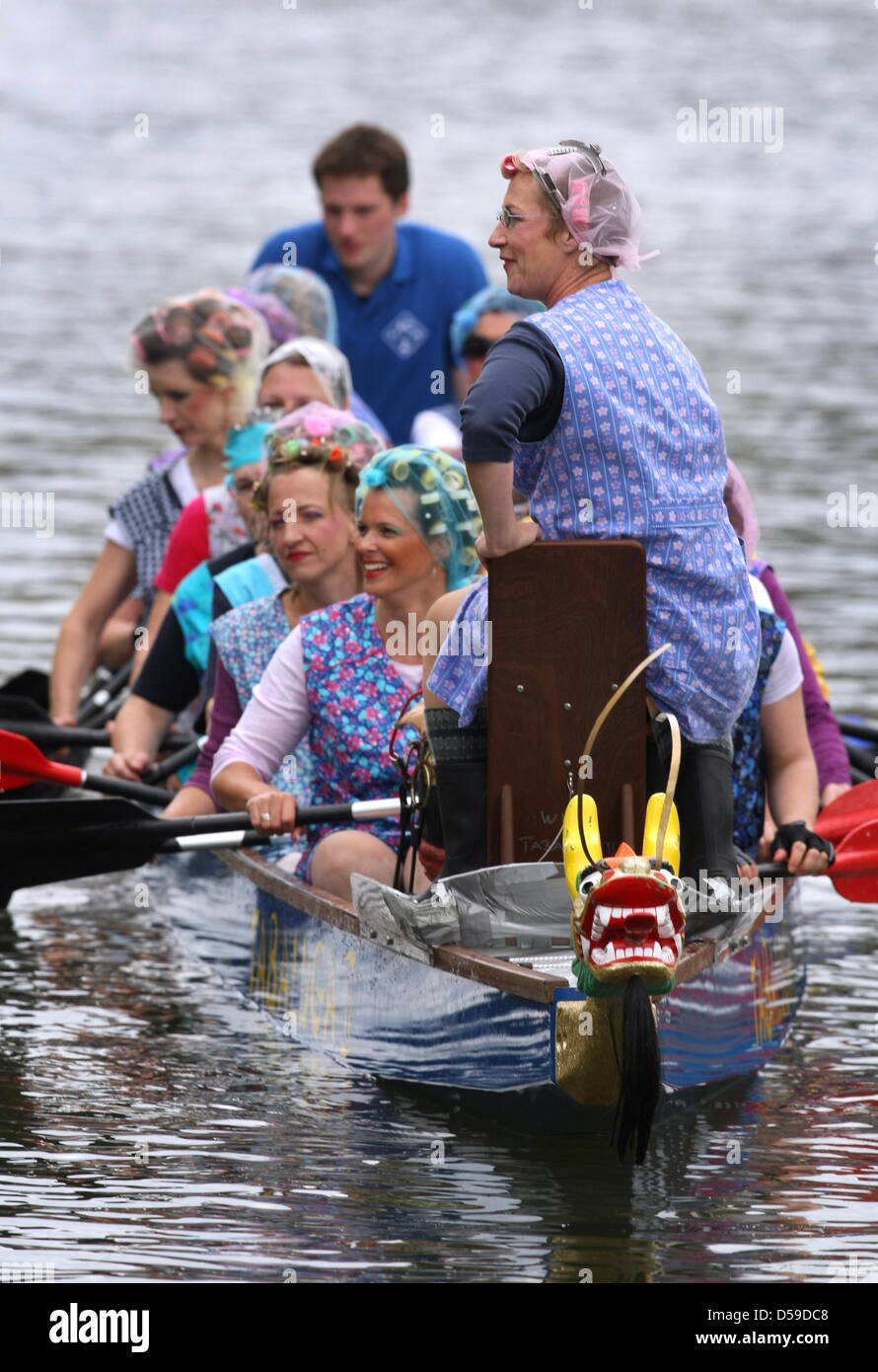 Women dressed-up as 'Wild Skirts' compete in a dragon boat race on Main ...