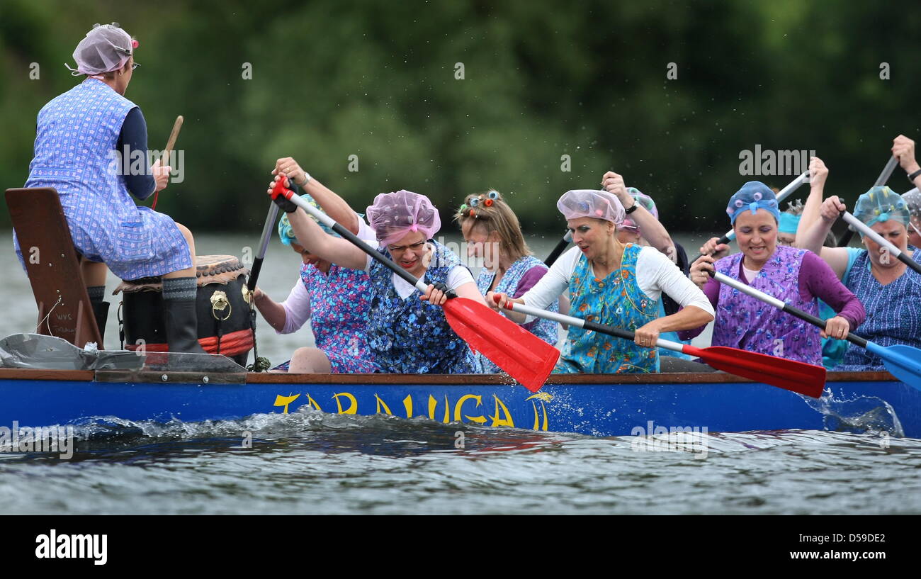 Women dressed-up as 'Wild Skirts' compete in a dragon boat race on Main ...