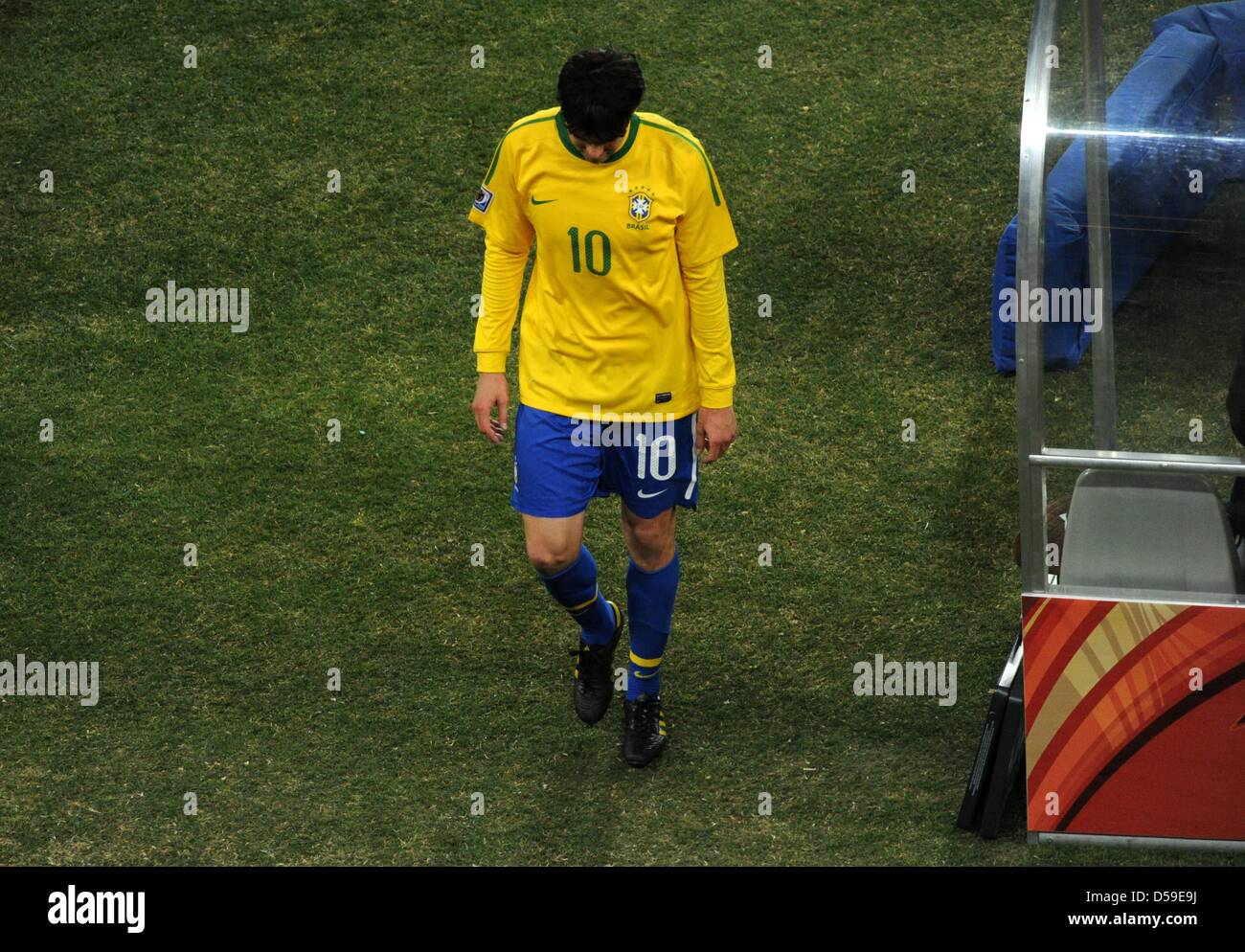 Brazil's Kaka leaves the pitch after being booked with the yellow-red ...