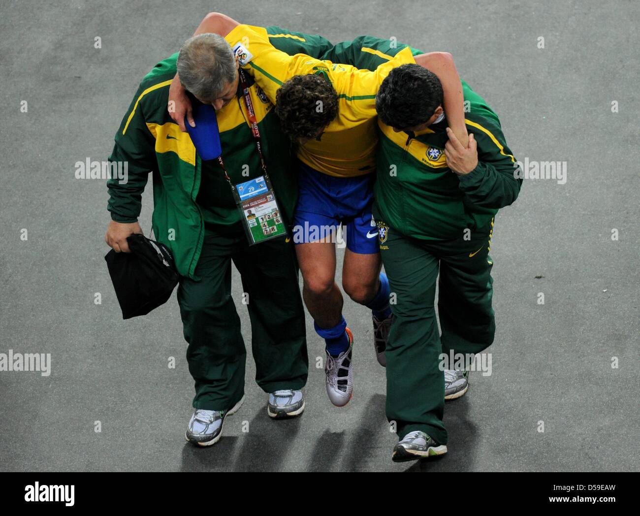 Elano (C) of Brazil is carried off the pitch during the FIFA World Cup ...