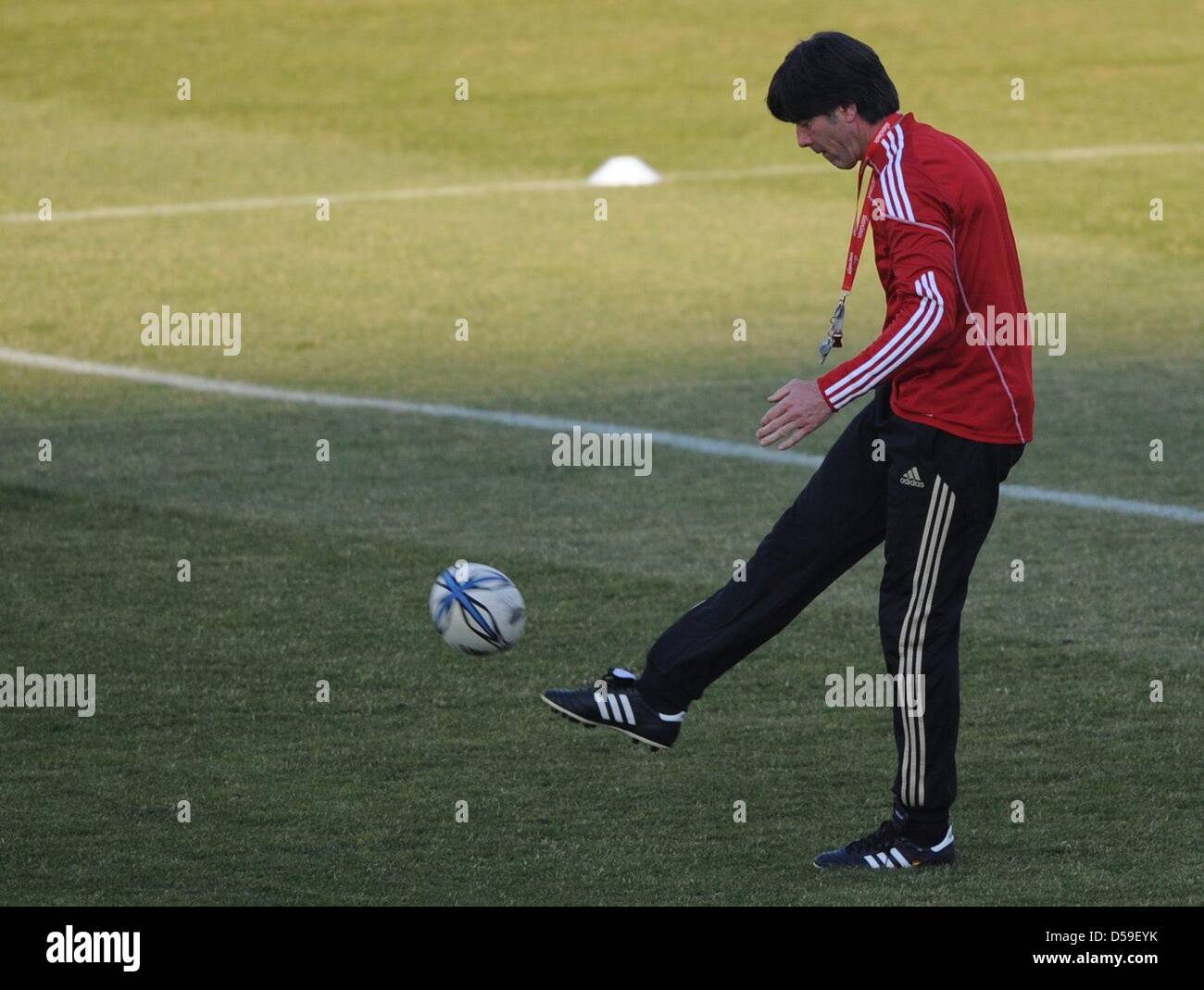 Germany's coach Joachim Loew kicks a rugby during a training session of ...