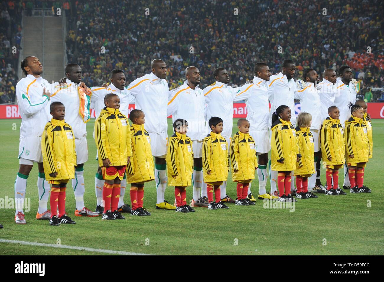 Ivory Coast's starting eleven listen to the national anthem prior to ...