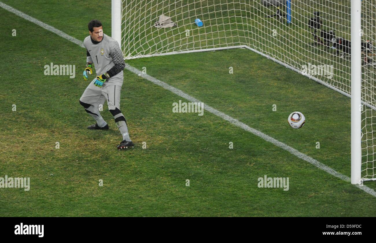 Brazil's goalkeeper Julio Cesar looks on as the ball goes into goal ...