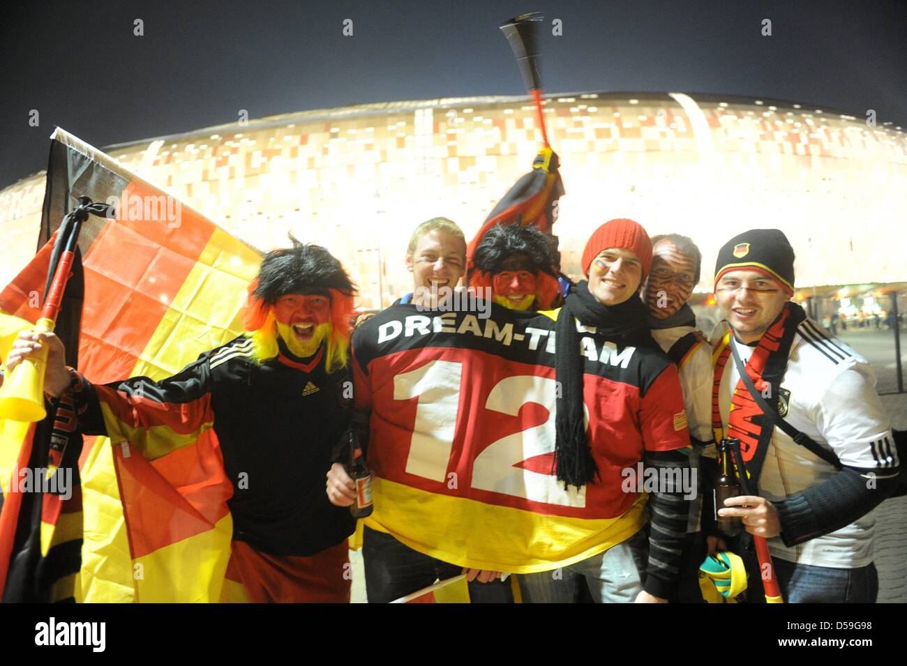 German fans celebrate in front of the illuminated stadium prior to the ...