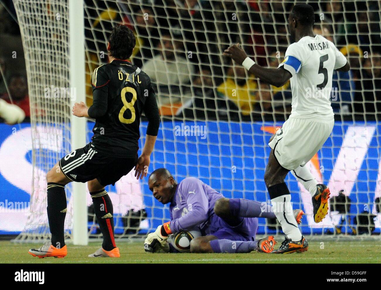 Goalkeeper Richard Kingson (C) of Ghana saves the ball next to teammate ...
