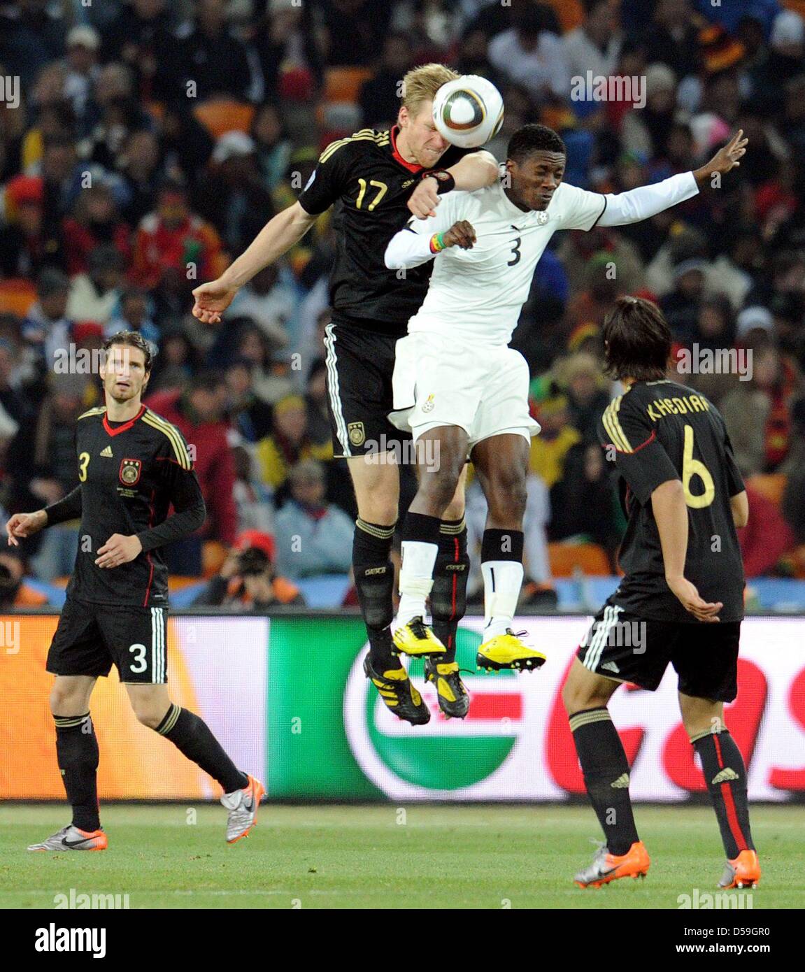 Asamoah Gyan (2-R) of Ghana vies with Per Mertesacker of Germany ...