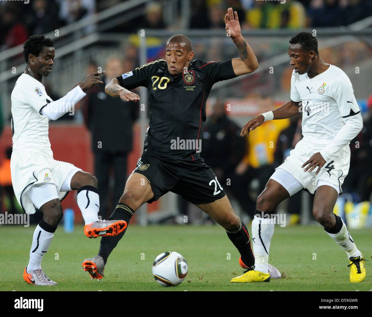 Germany's Jerome Boateng (C) and Ghana's Anthony Annan (L) and John ...