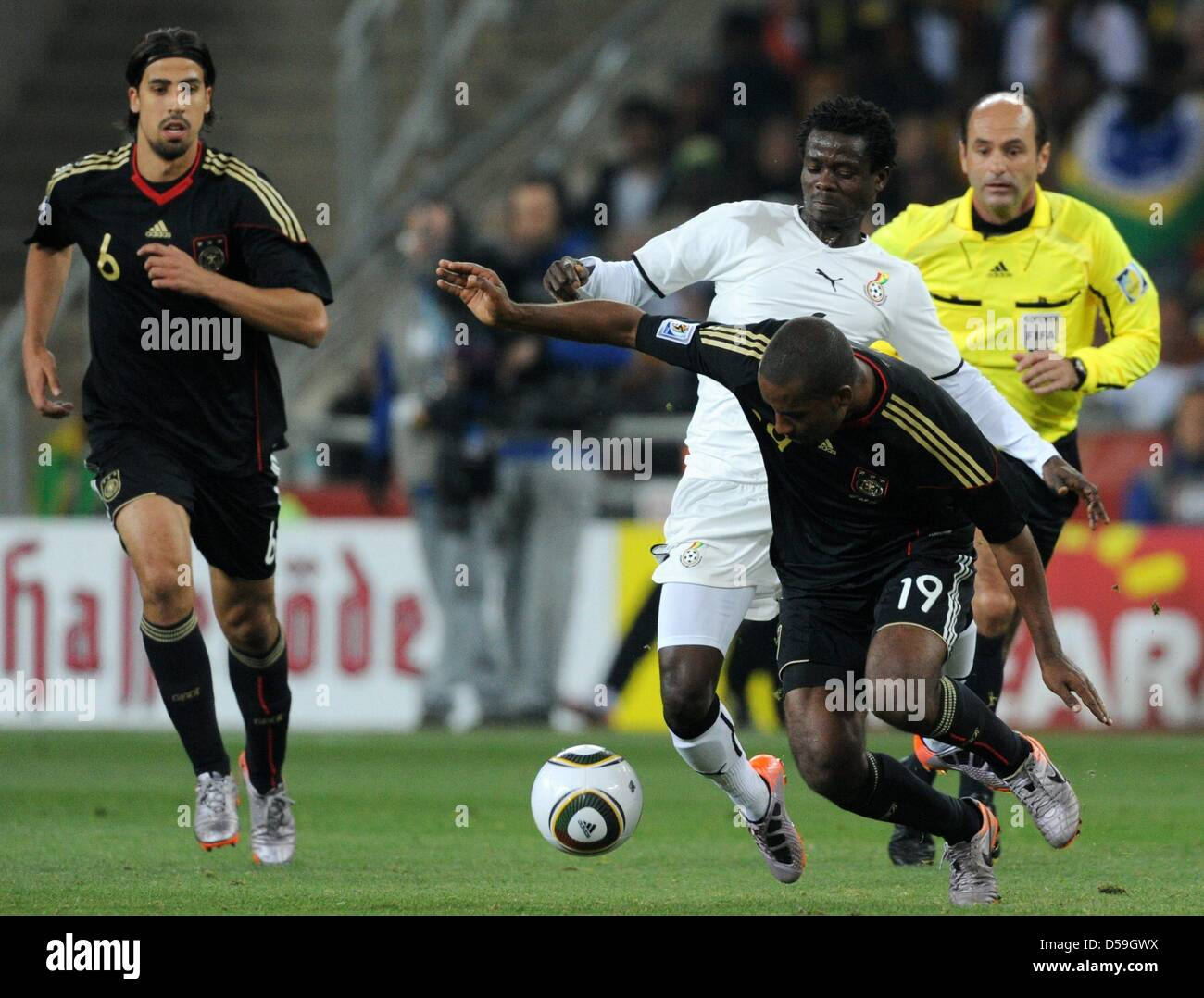 Germany's Cacau (R) and Sami Khedira and Ghana's Anthony Annan vie for ...