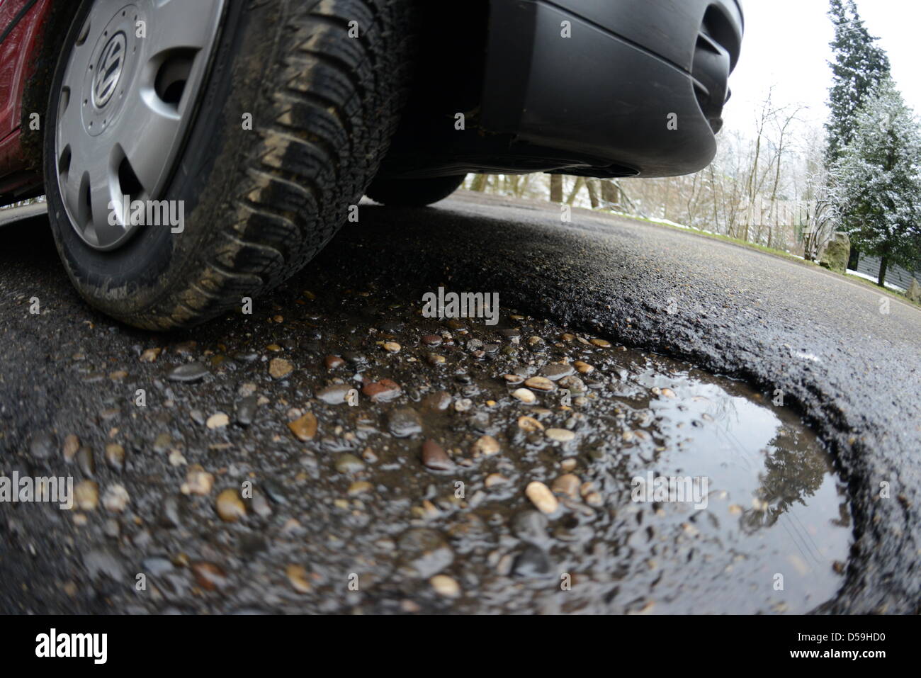A vehicle parks in front of a Pothole in the road in Au, Germany, 27 ...