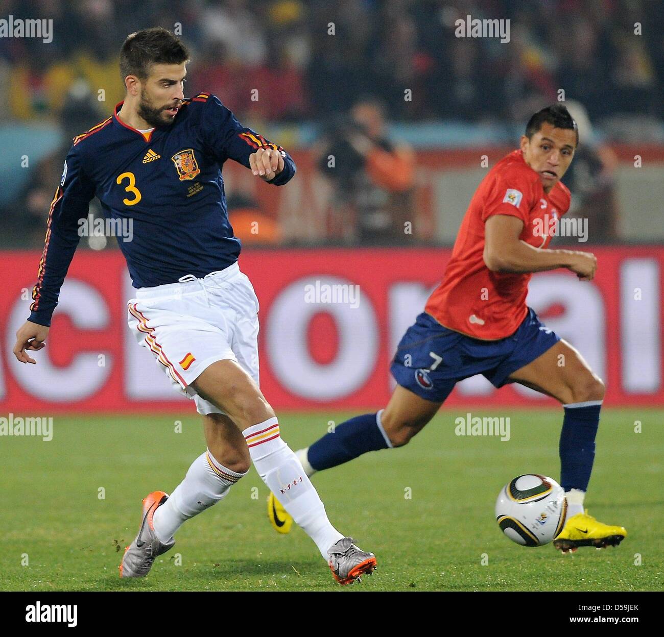 Spain's Gerard Pique (L) and Chile's Alexis Sanchez vie for the ball ...