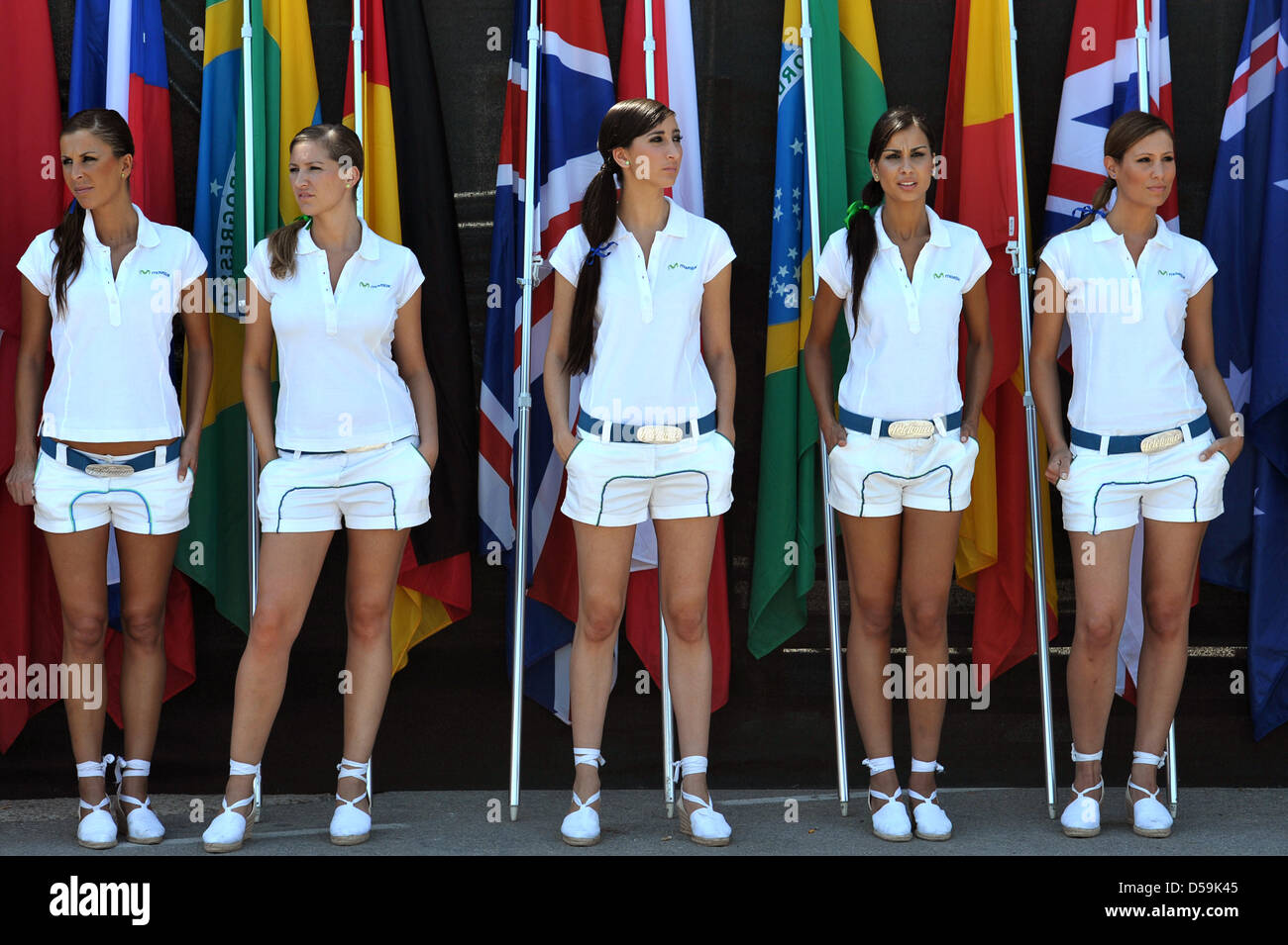 Gridgirls are staged with their flags for the starting grid at the ...