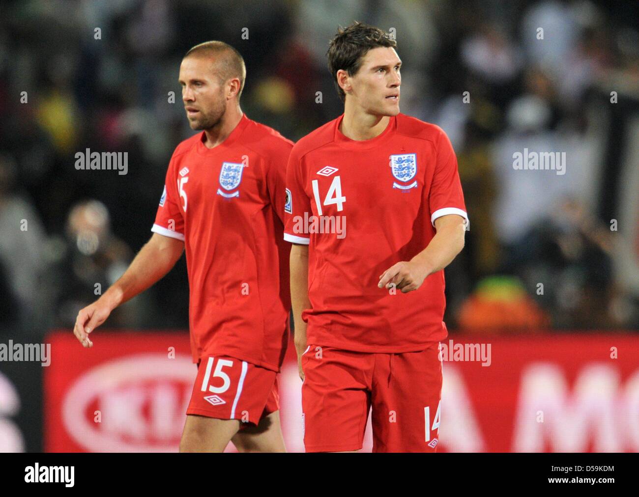 Matt Upson (L) and Gareth Barry (R) of England leave the pitch after ...