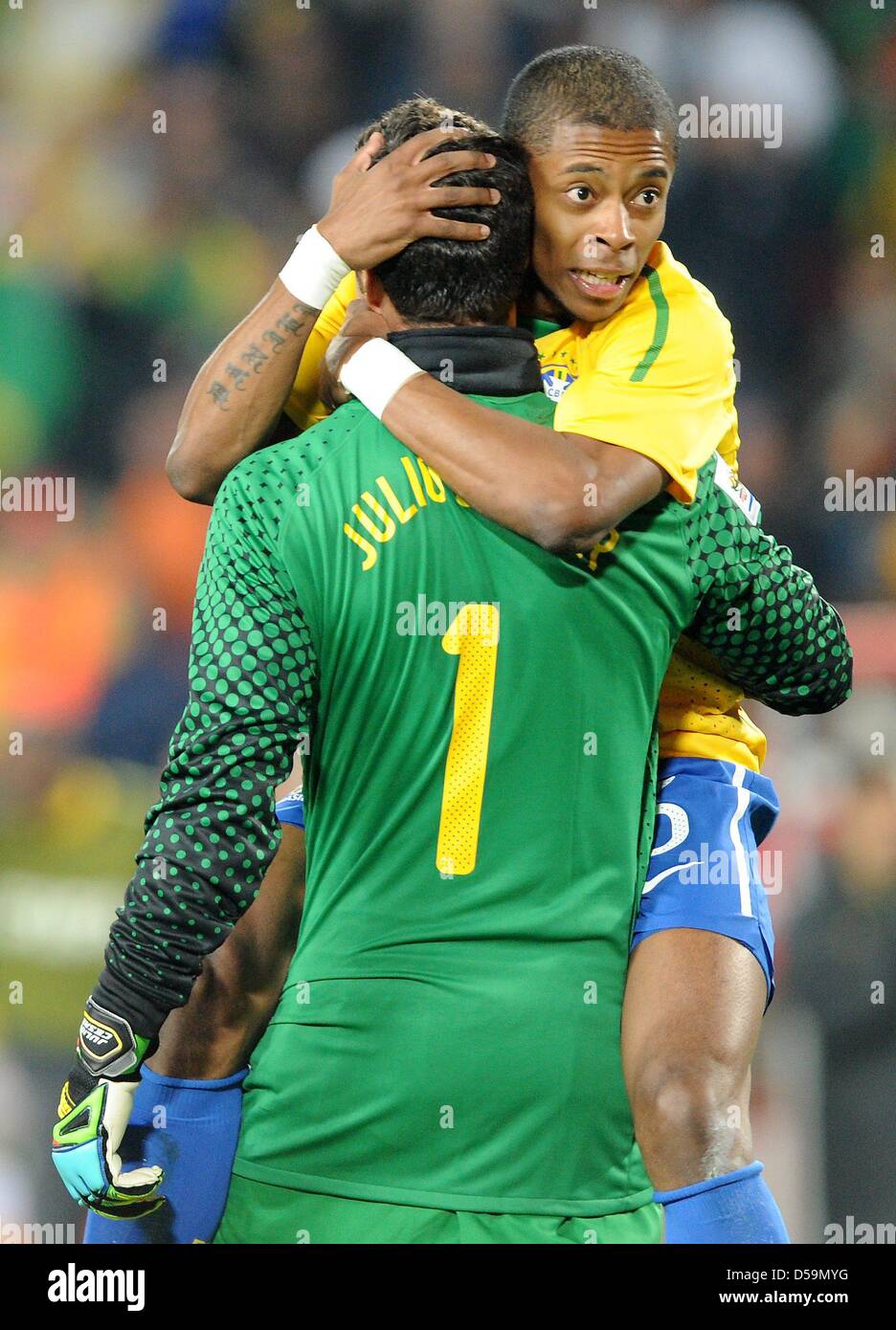 Brazil's goalkeeper Julio Cesar celebrates with team mate Michel Bastos ...