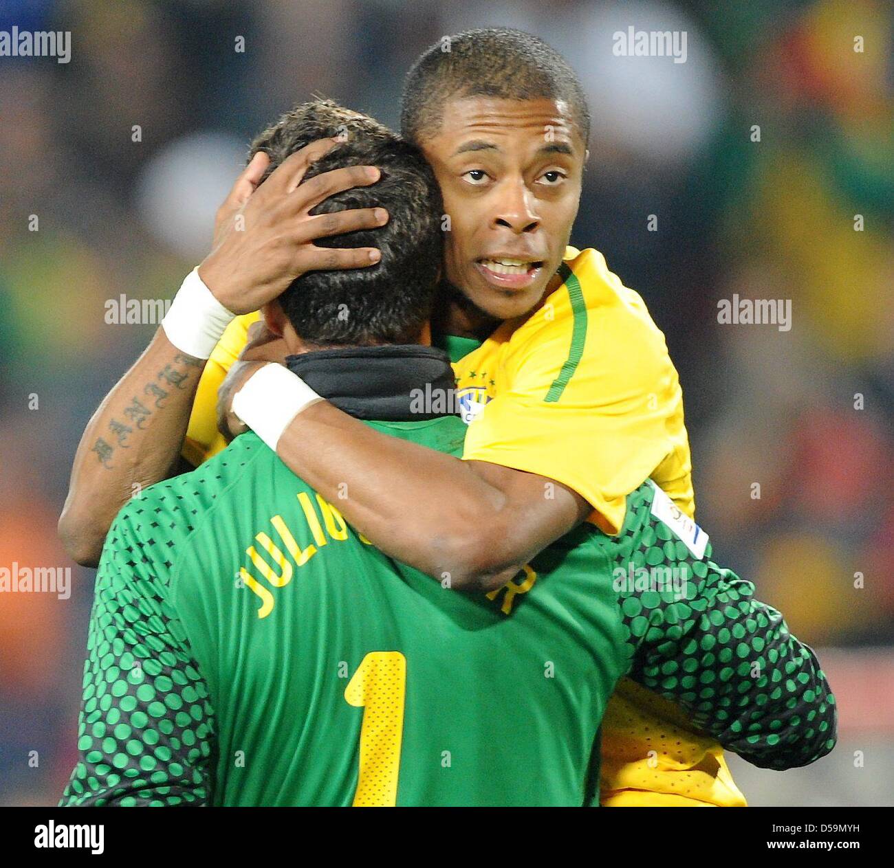 Brazil's goalkeeper Julio Cesar celebrates with team mate Michel Bastos ...