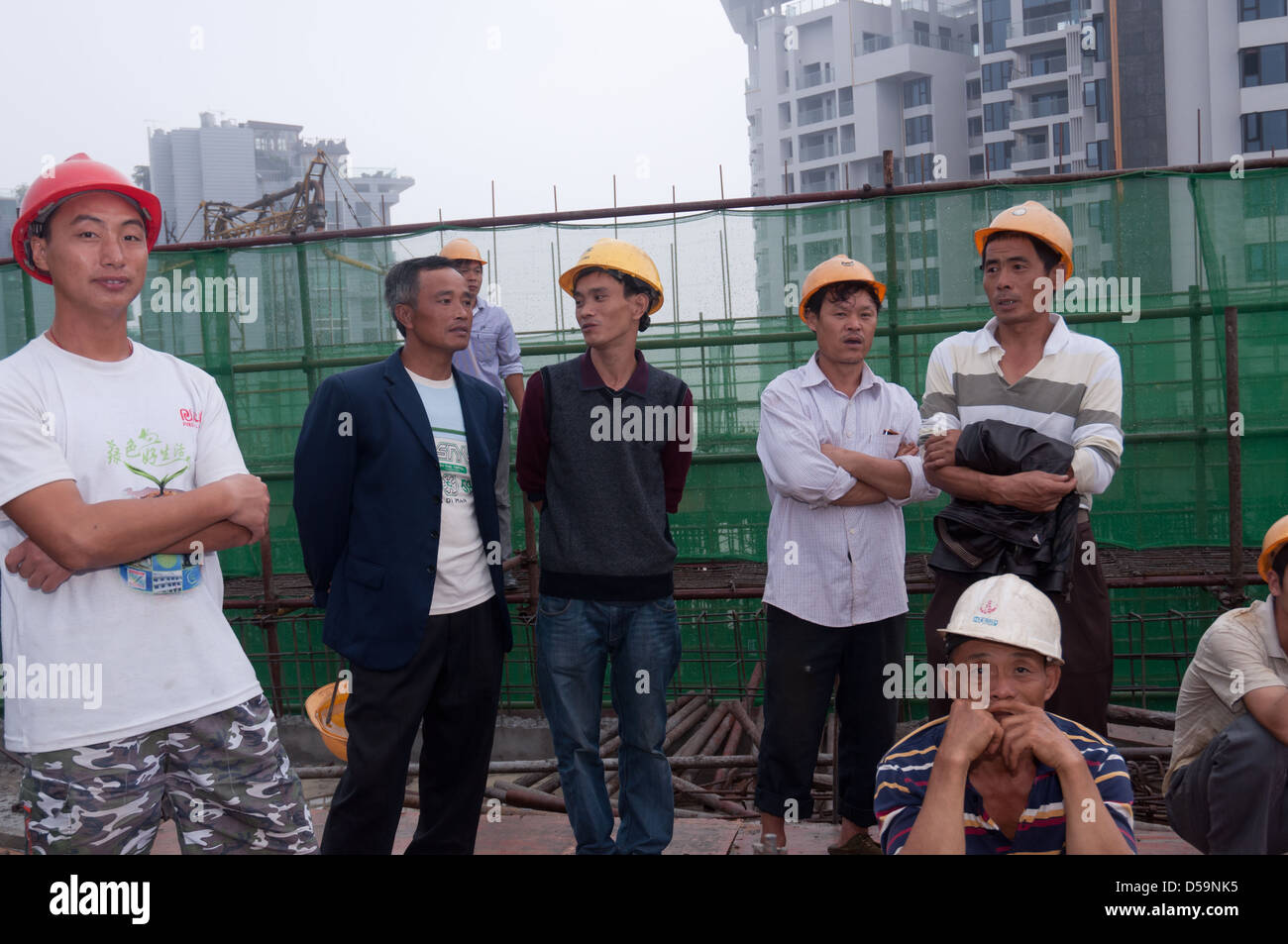 Chinese construction workers standing rest on a buildings roofs Stock ...