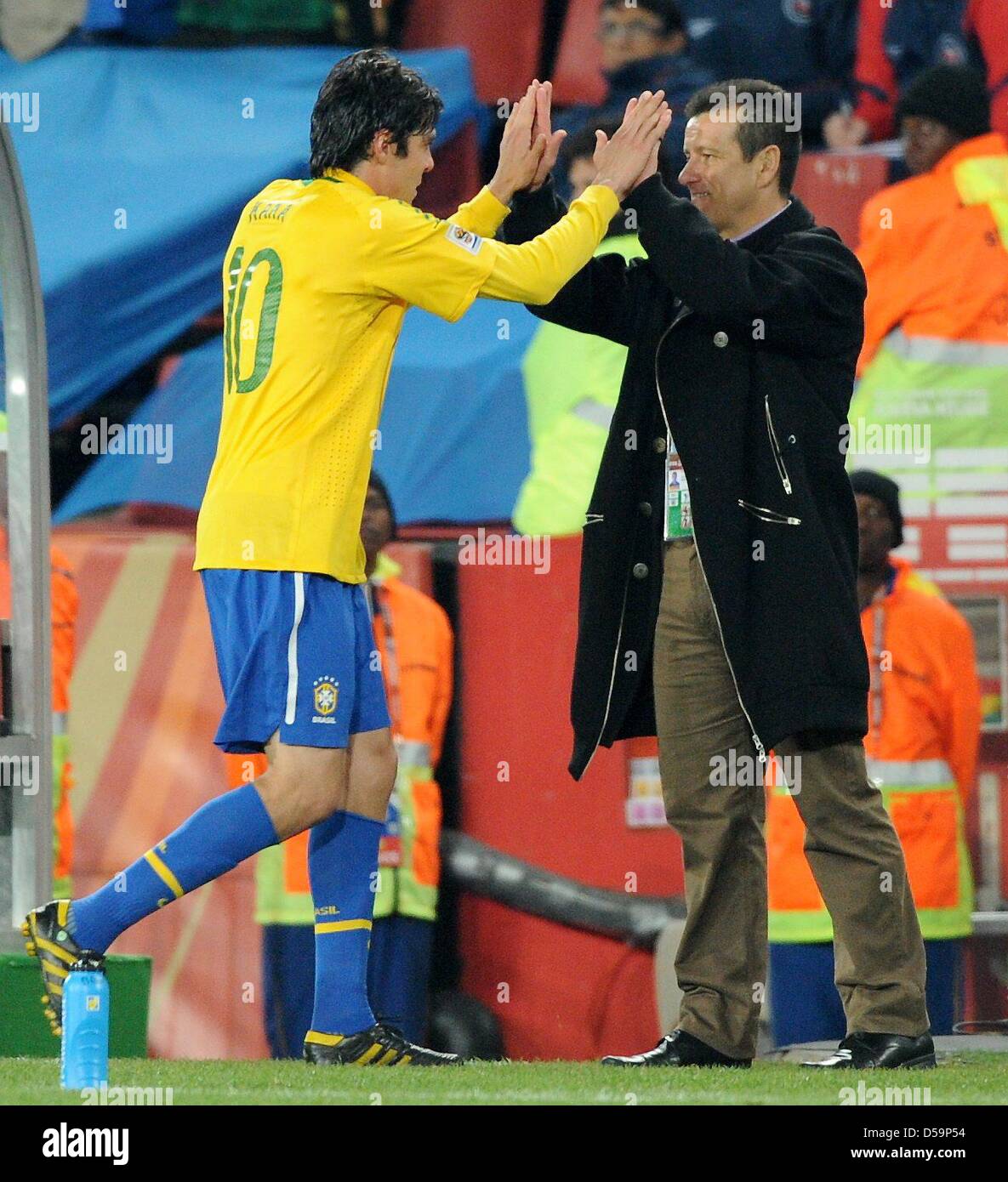 Brazil's Kaka high fives with coach Carlos Dunga as his is being ...