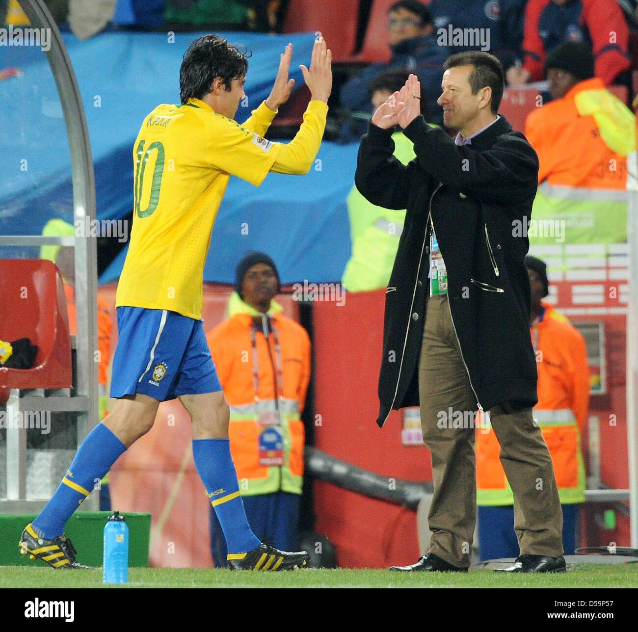 Brazil's Kaka high fives with coach Carlos Dunga as his is being ...