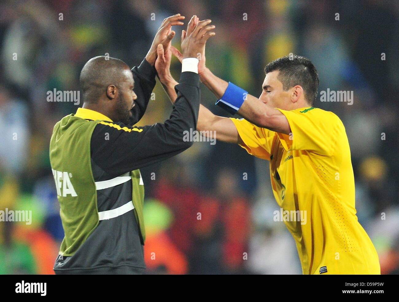 Lucio of Brazil celebrates with Grafite (L) after the final whistle of ...