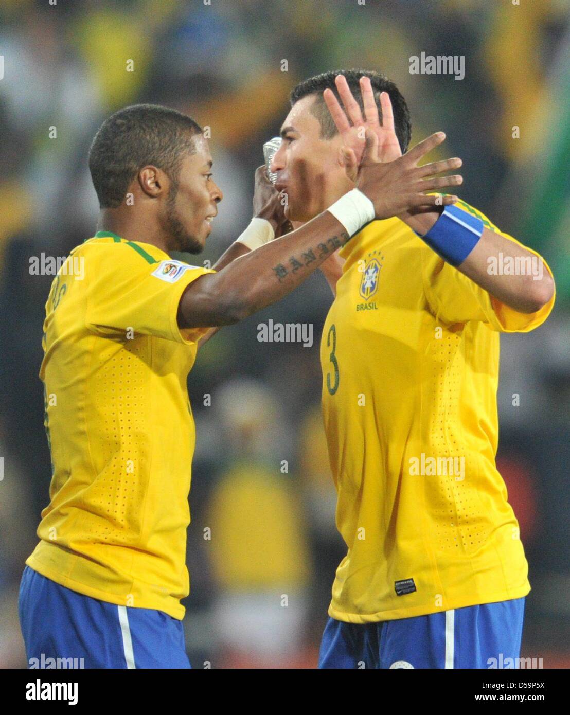 Lucio of Brazil celebrates with Michel Bastos (L) after the final ...