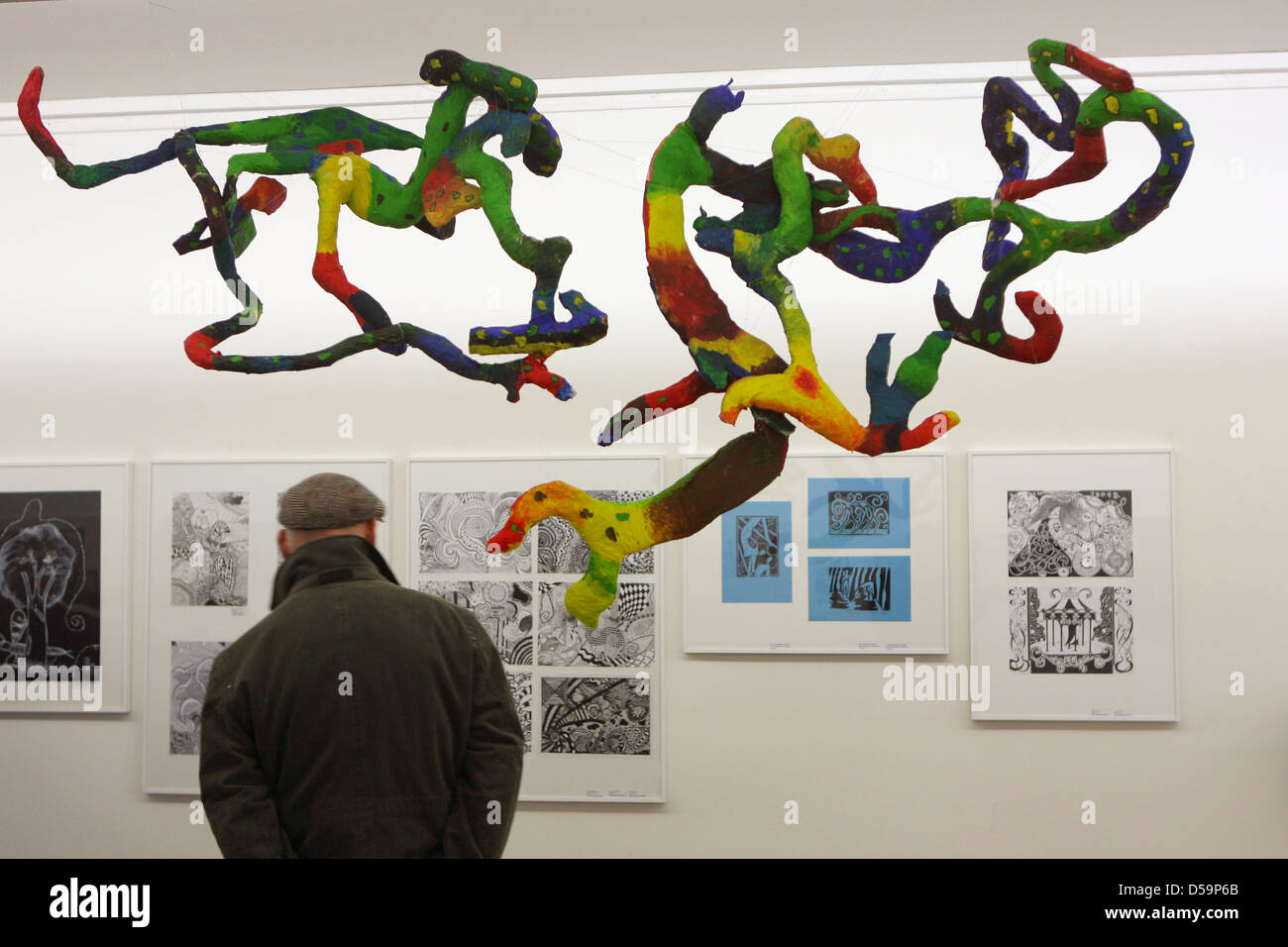 A visitor looks at objects featured in the exhibition 'Pupils exhibit ...