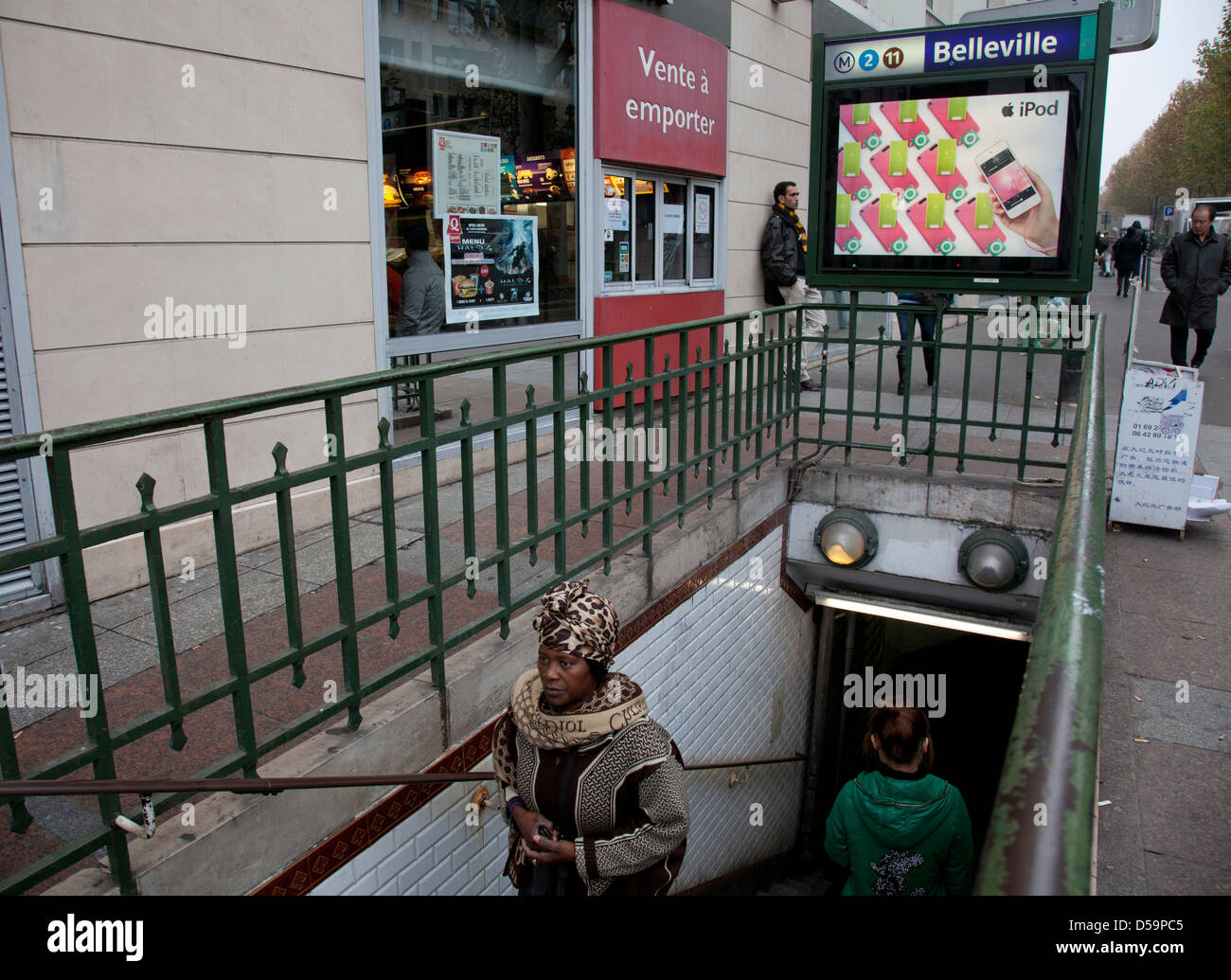 African woman at entrance to Metro station in Belleville, Paris, France ...