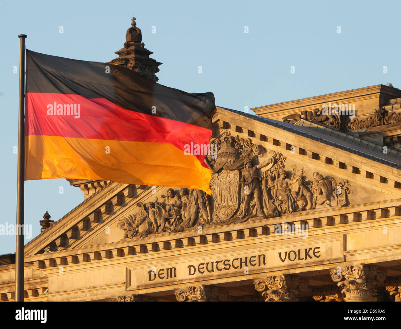 A German national flag flies in front of the Reichstag building in the ...