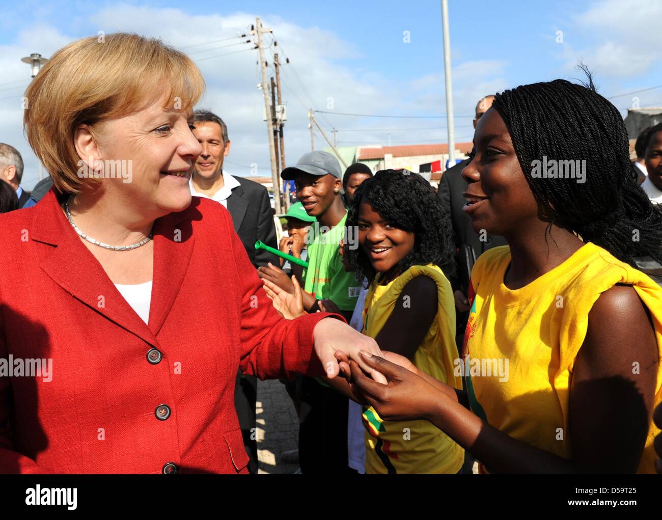 The German Chancellor Angela Merkel talks to school children during her ...