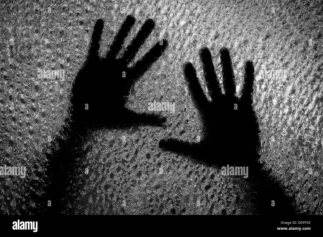 A persons hands against a glass window Stock Photo - Alamy