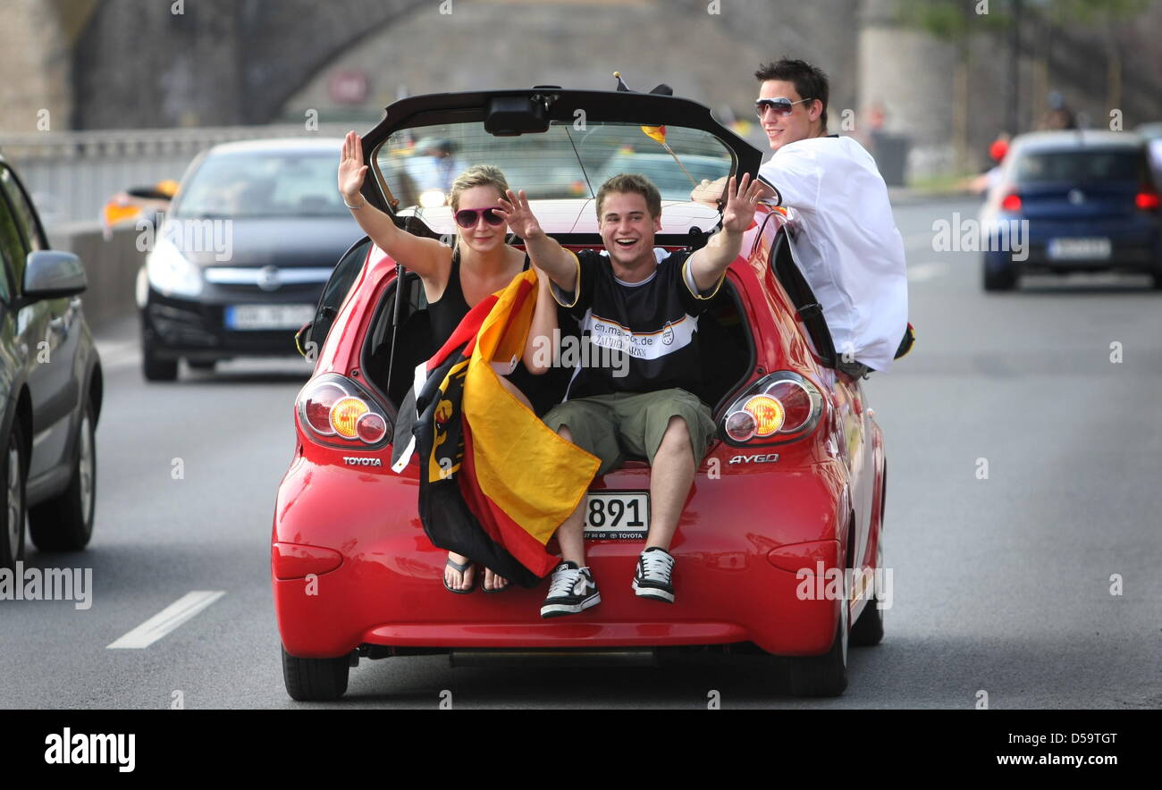 Sitting in the trunk of a car, soccer fans in Würzburg (Lower Franconia ...
