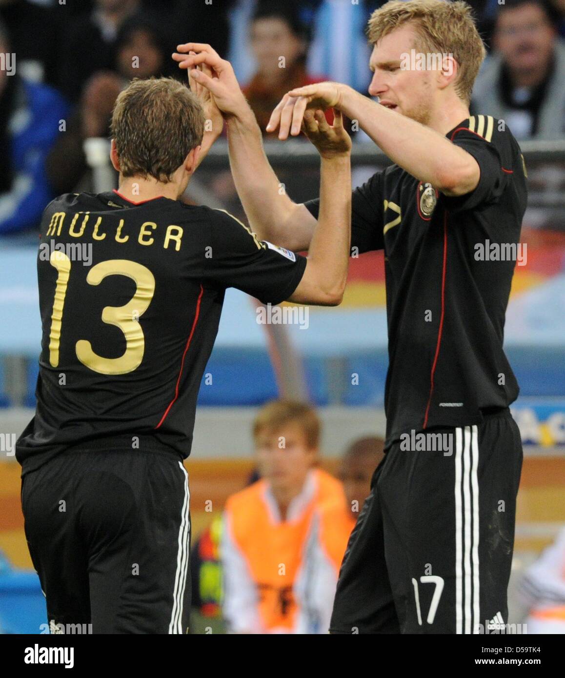 Germany's Thomas Mueller high fives with team mate Per Mertesacker ...