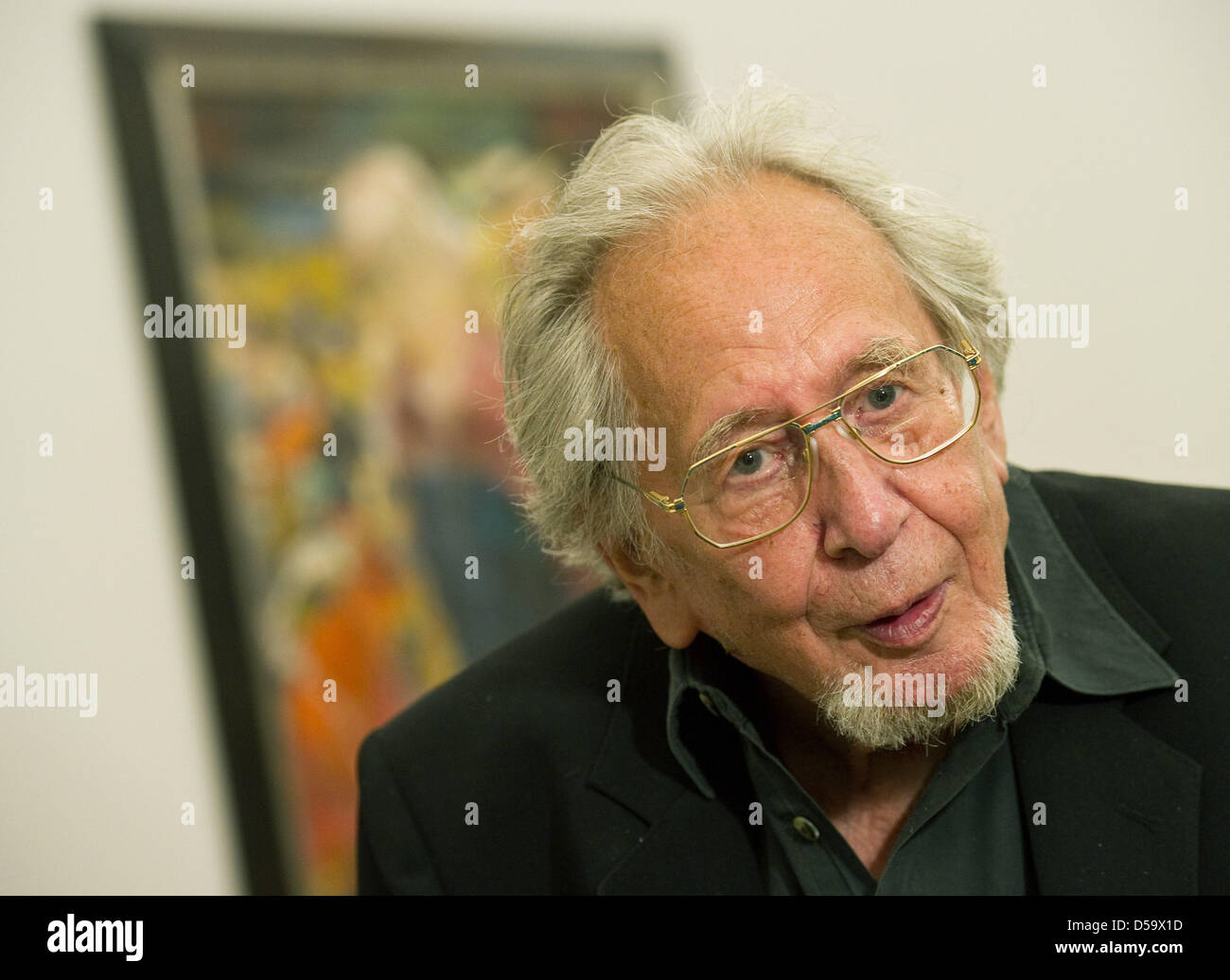 German painter Bernhard Heisig smiles in front of his work in ...