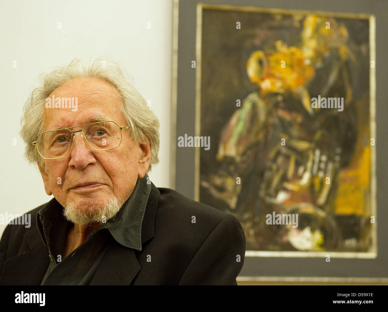 German painter Bernhard Heisig smiles in front of his work in ...