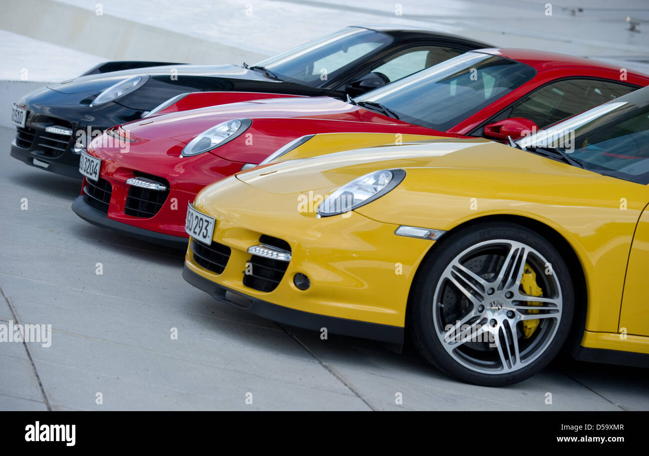 Three Porsche cars lined up in the German antional colours black, red ...