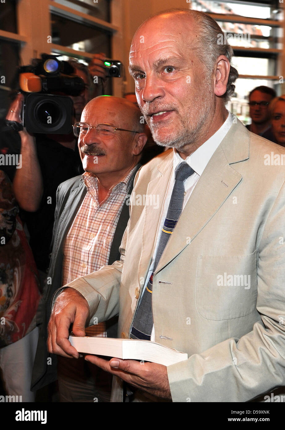 US actor John Malkovich (R) arrives with German filmmaker Volker ...
