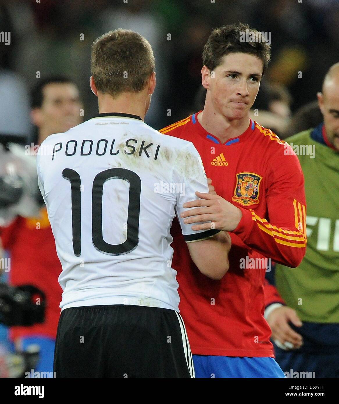 Germany's Lukas Podolski embraces Spain's Fernando Torres after the ...