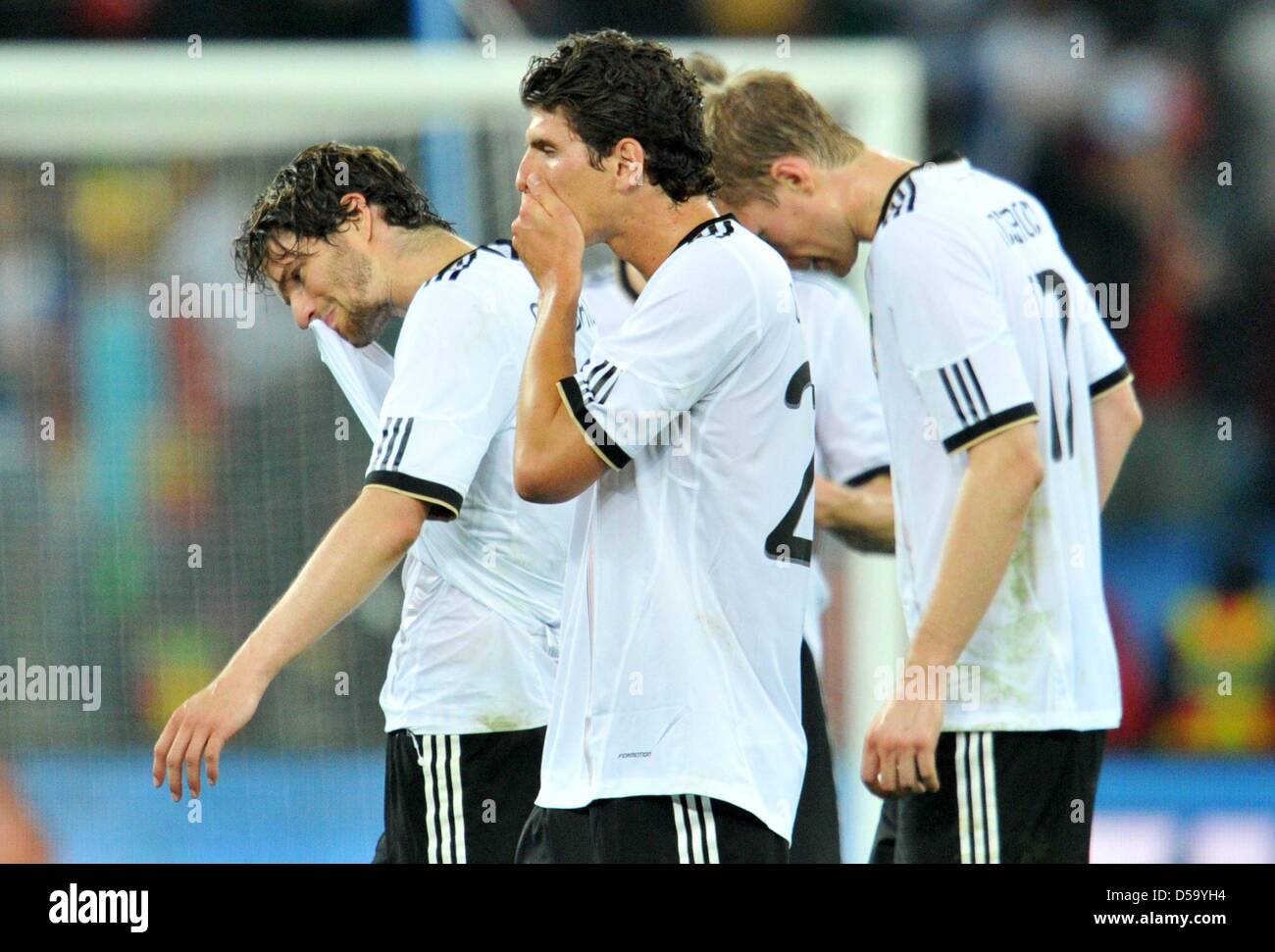 Arne Friedrich (L-R), Mario Gomez and Per Mertesacker of Germany react ...
