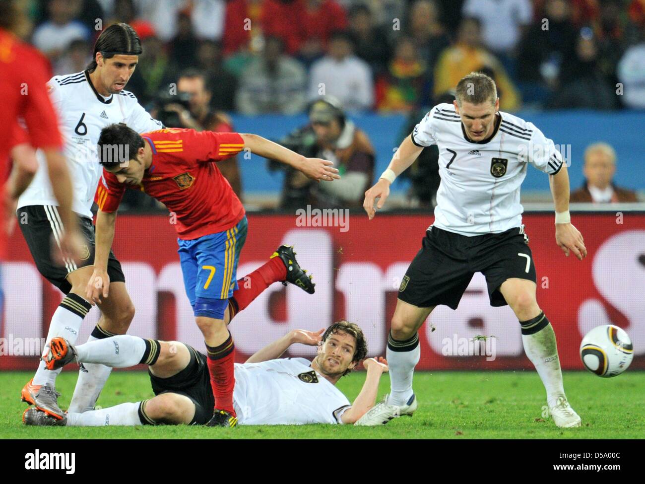 Sami Khedira (L), Arne Friedrich (bottom) and Bastian Schweinsteiger of ...