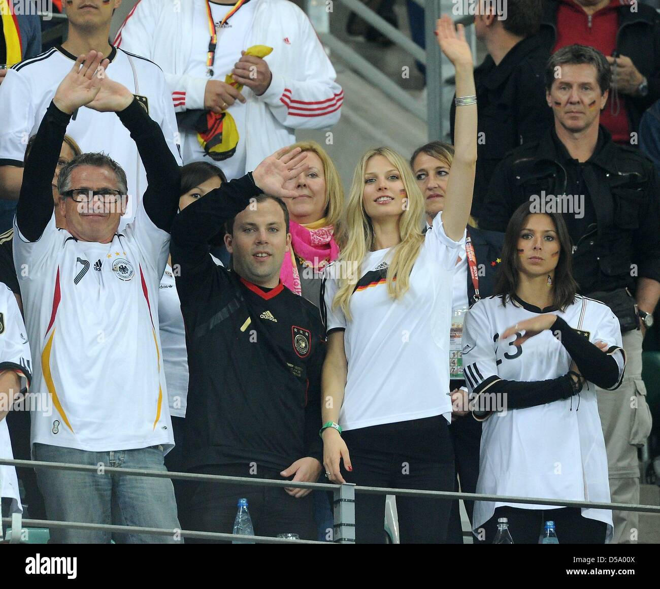 Daniela Loew (5th L with pink scarf), the wife of German headcoach ...