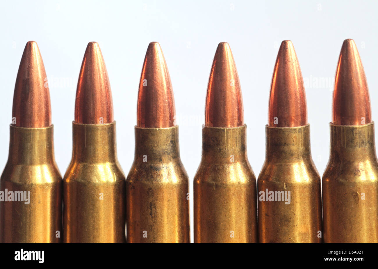Row of rifle bullets on white background Stock Photo - Alamy