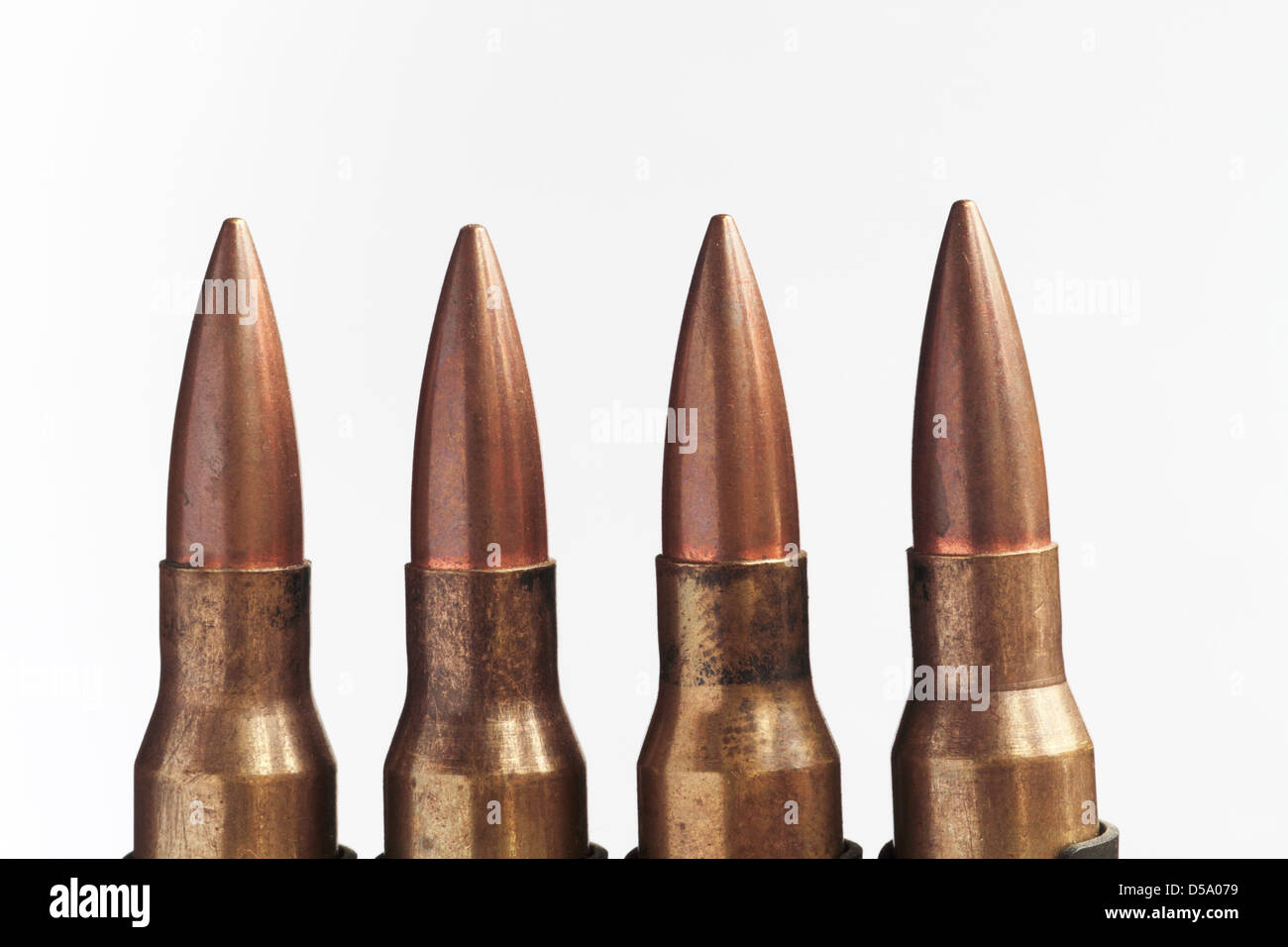 Row of rifle bullets on white background Stock Photo - Alamy